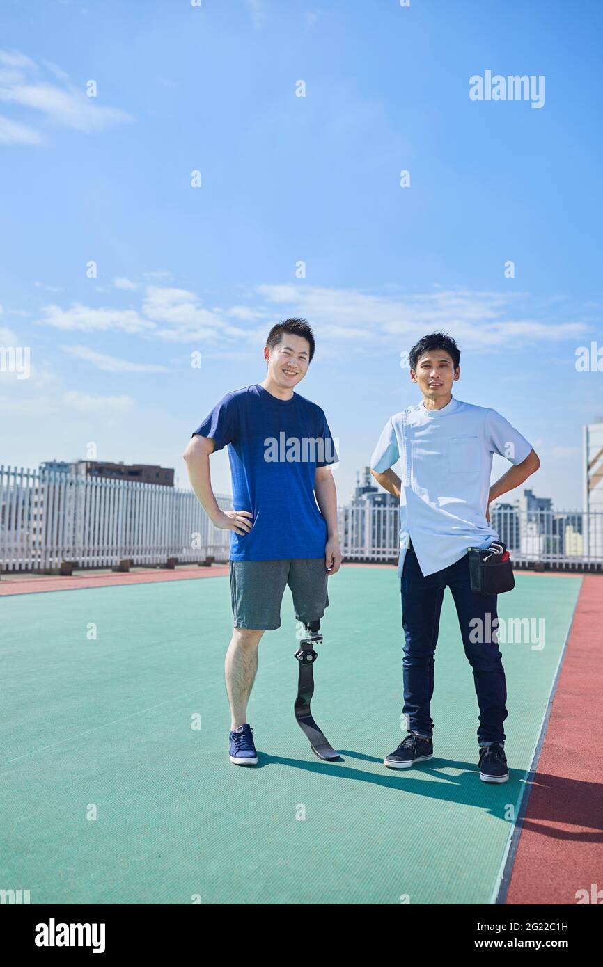 Japanese prosthetist working with amputee on rooftop Stock Photo - Alamy
