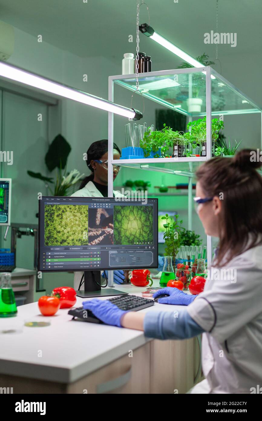 Chemist scientist woman typing biochemistry expertise on computer while ...