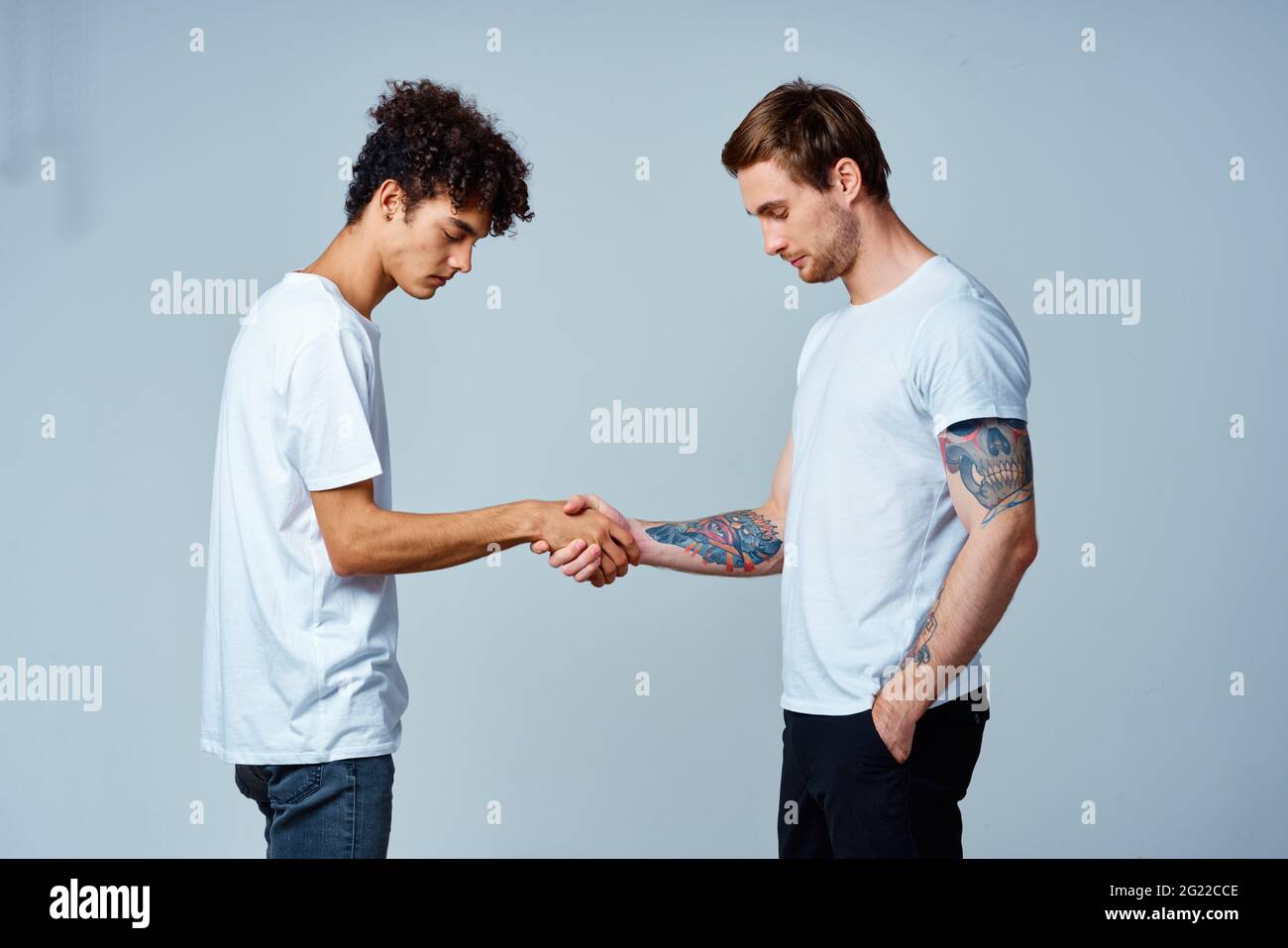 two men friendship shaking hands isolated background Stock Photo - Alamy