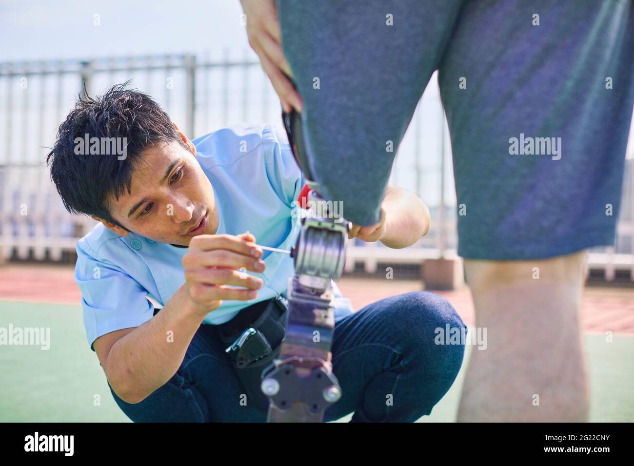 Japanese prosthetist working with amputee on rooftop Stock Photo - Alamy