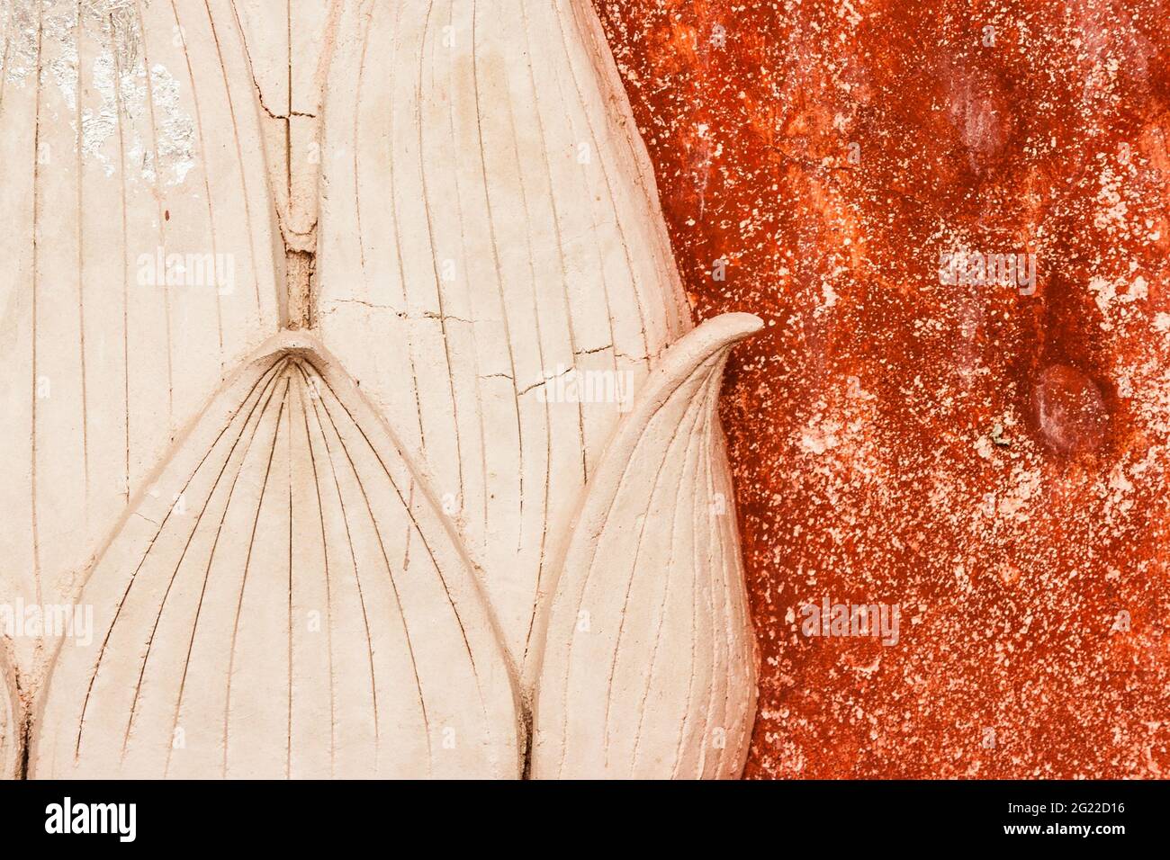 Lotus cement sculpture with grunge red background Stock Photo - Alamy