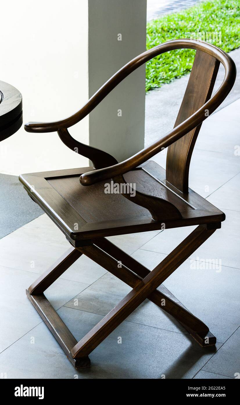 Glossy coating oak color wooden chair with armrest Stock Photo - Alamy