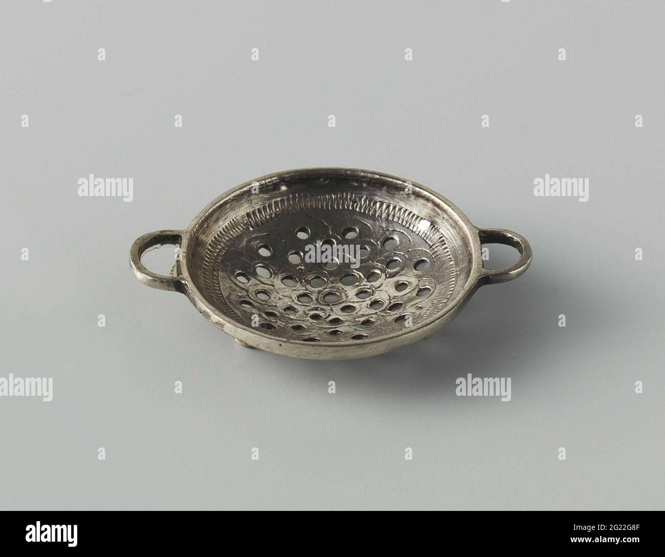 Colander. Colander with two handles and three legs. The colander has ...
