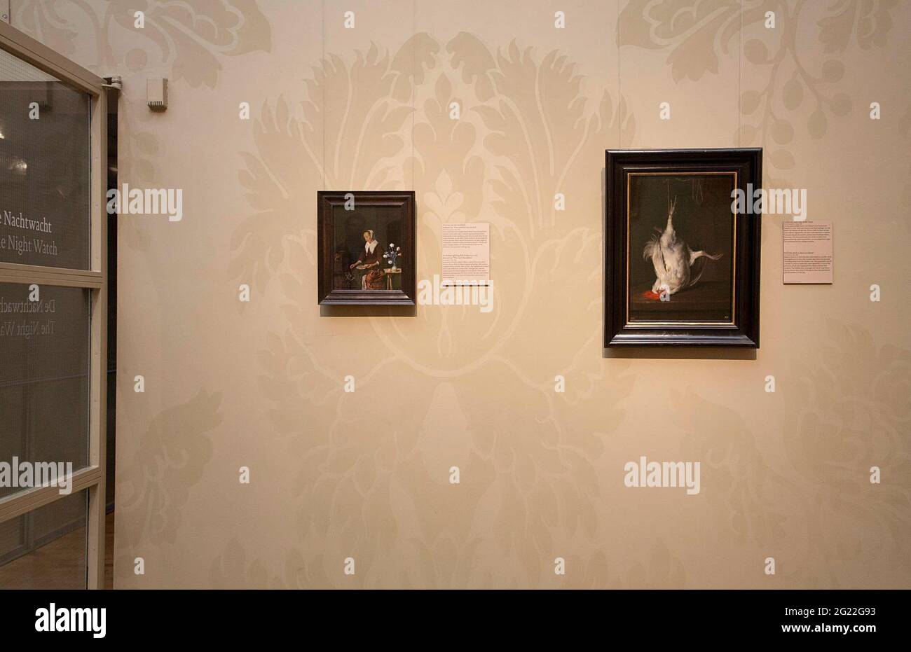 Painting of a woman carrying a cat and a still life of a dead rooster ...