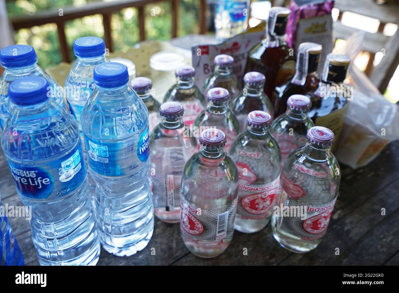 Rows of water, soda and whiskey on wooden table Stock Photo - Alamy