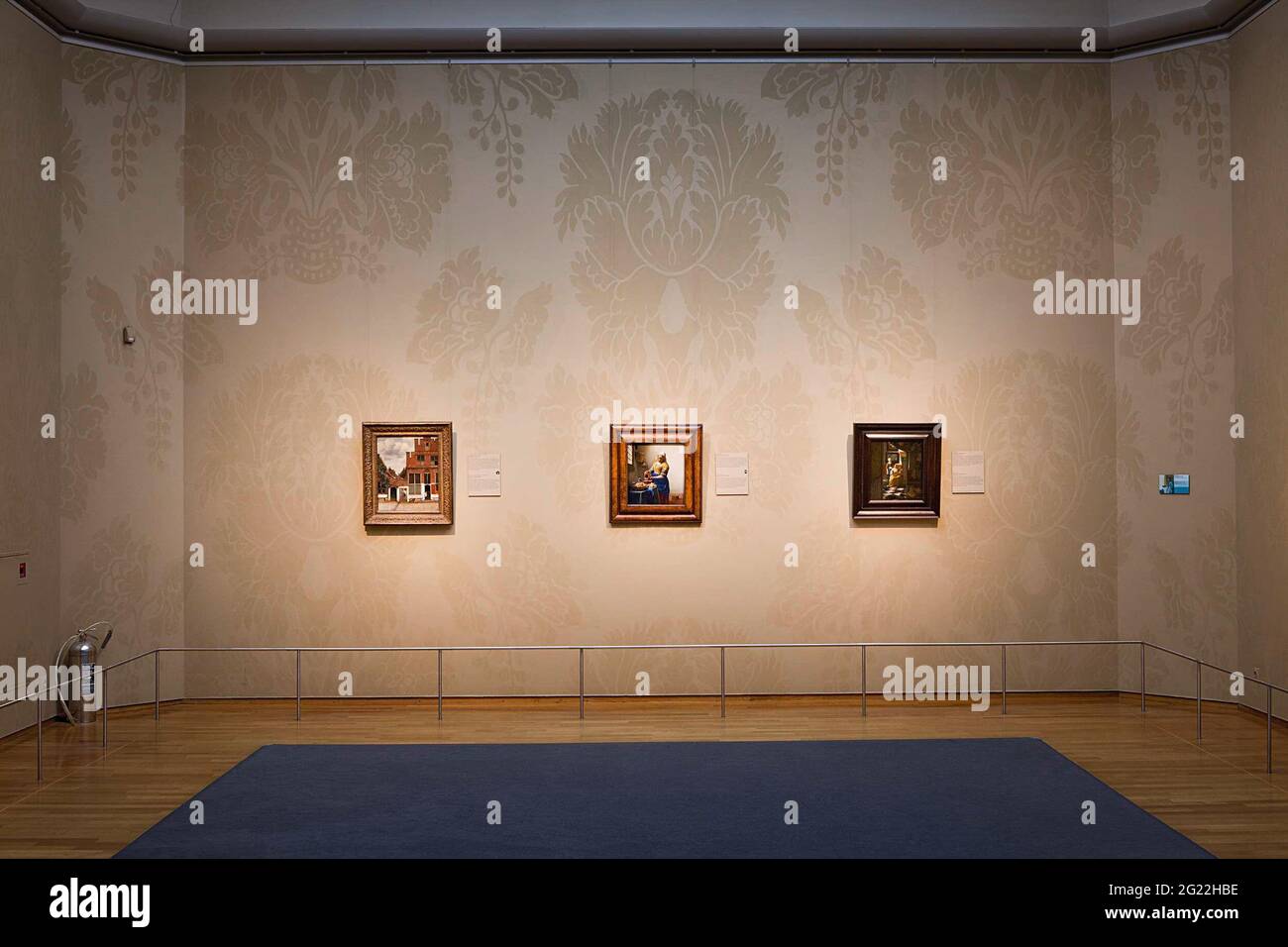 Wall with three paintings by Johannes Vermeer and an extinguisher left ...