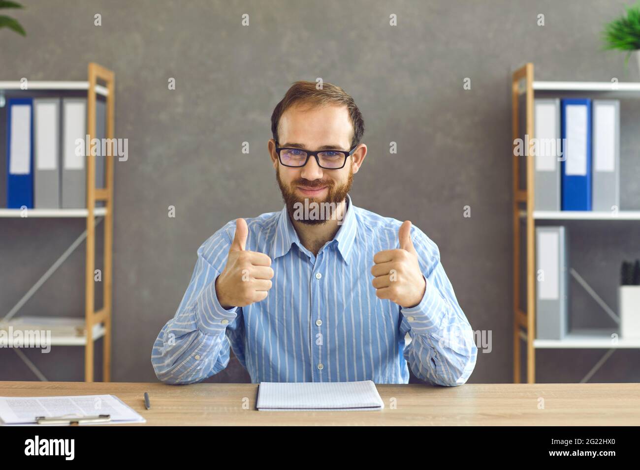 Happy young businessman or office worker showing that he's satisfied ...