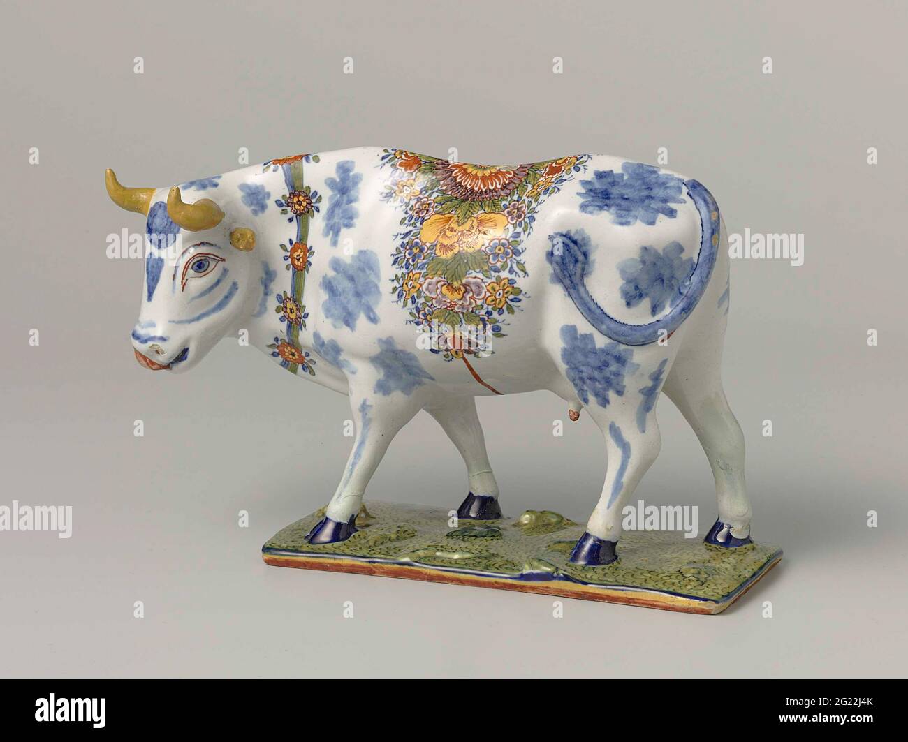 Decorative object; cow. Animal figure of faience, representing a cow ...