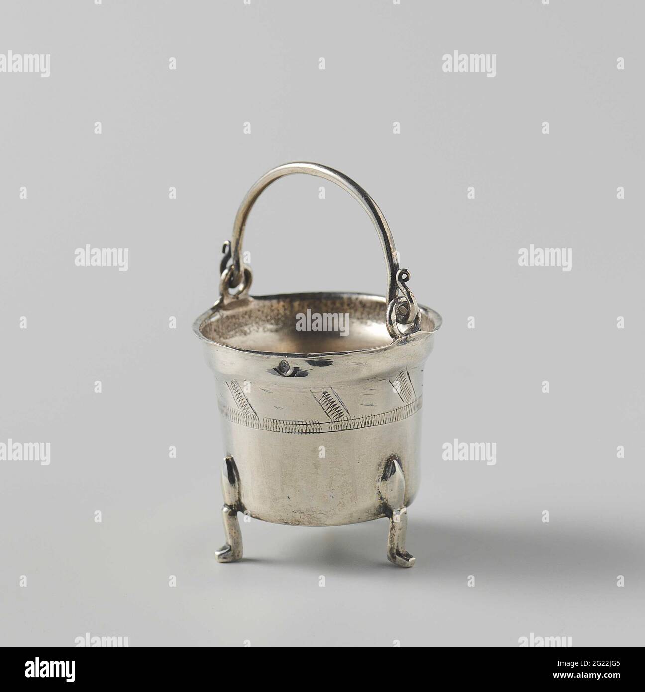 Cooking pot. Round pot on three legs and with a handle. The pot has a ...
