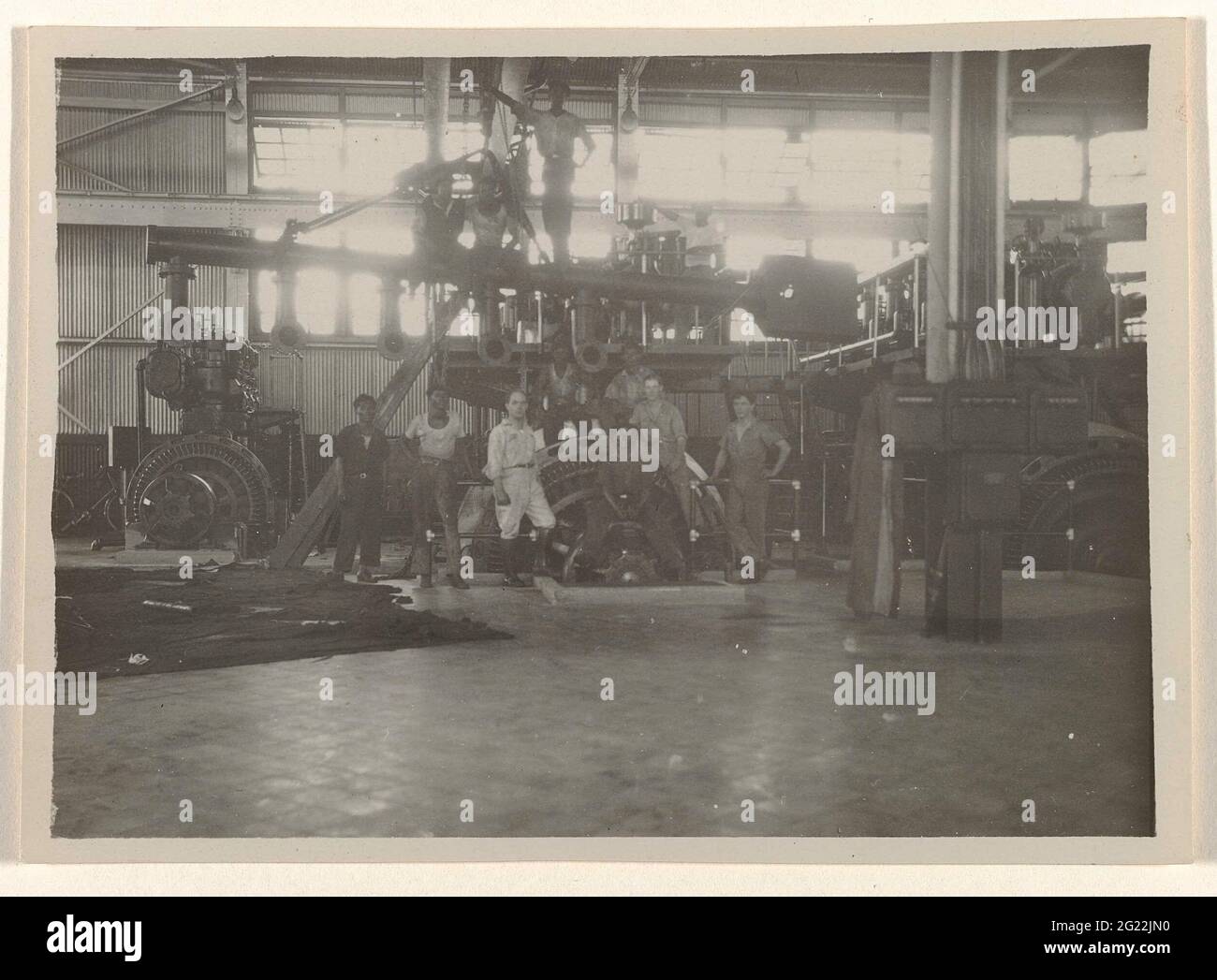 Power House in Moengo with employees. Employees posing at turbines in ...