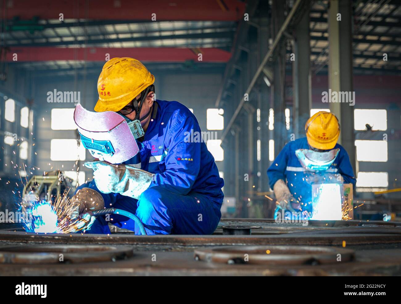 HAI'AN, CHINA - JUNE 8, 2021 - Workers produce crawler cranes at a ...