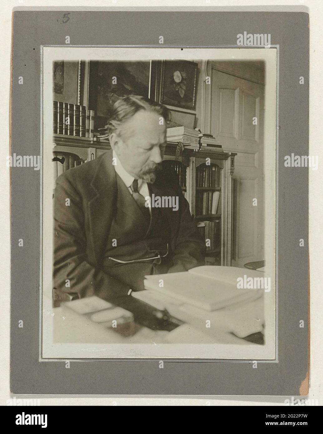 Andries Bonger, seated at the table, reading a book Stock Photo - Alamy