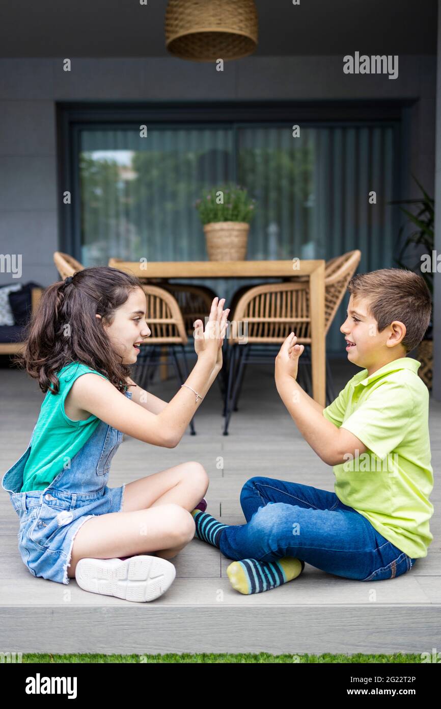 Two friends clapping hands at home Stock Photo - Alamy