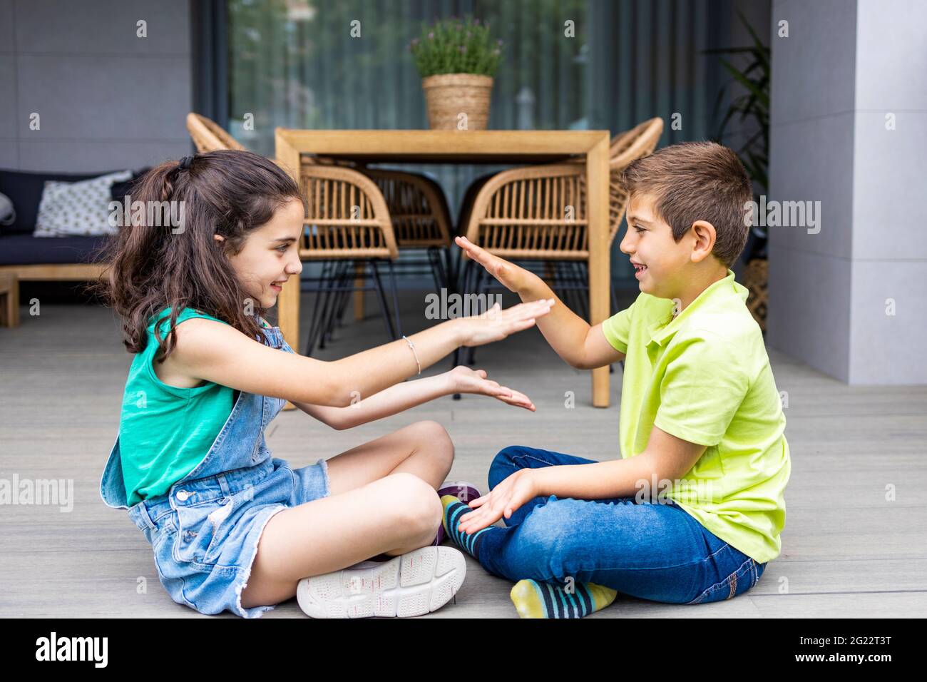Two friends clapping hands at home Stock Photo - Alamy