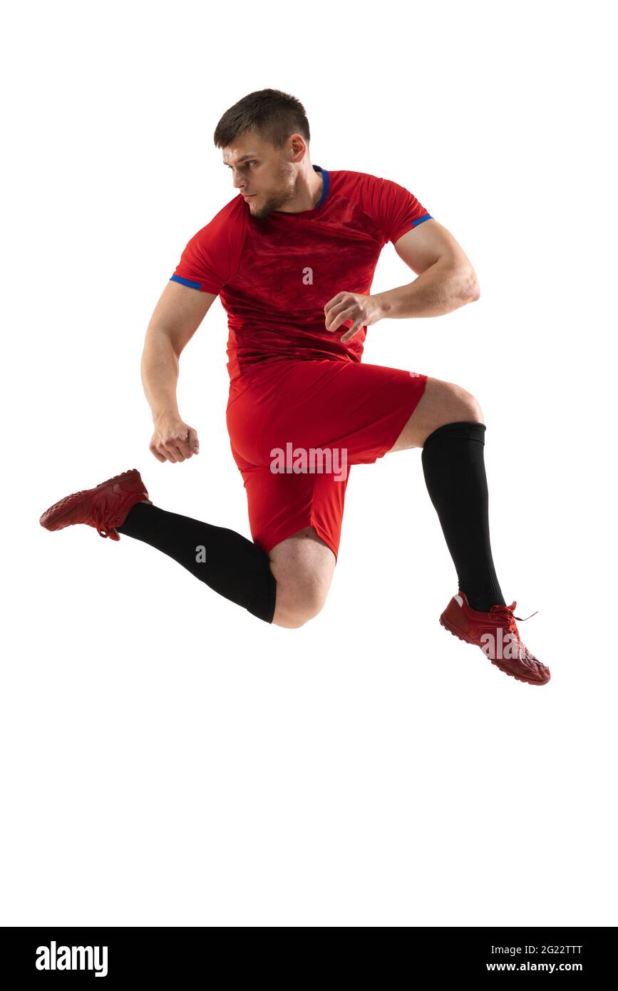 Powerful, flying above the field. Young football, soccer player in ...