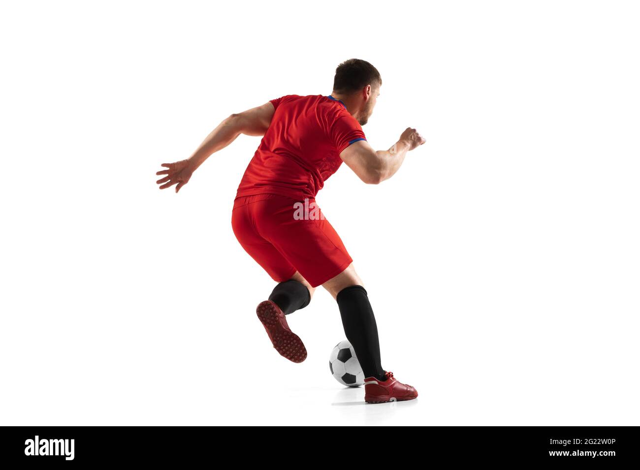 Powerful, flying above the field. Young football, soccer player in ...