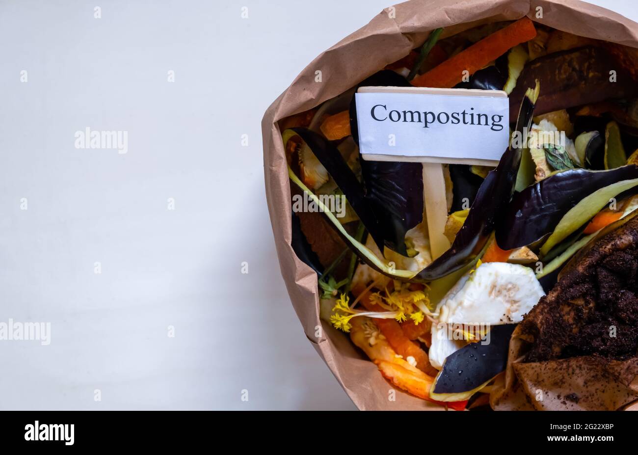 Organic food waste. Paper bag with vegetable leftovers for compost ...