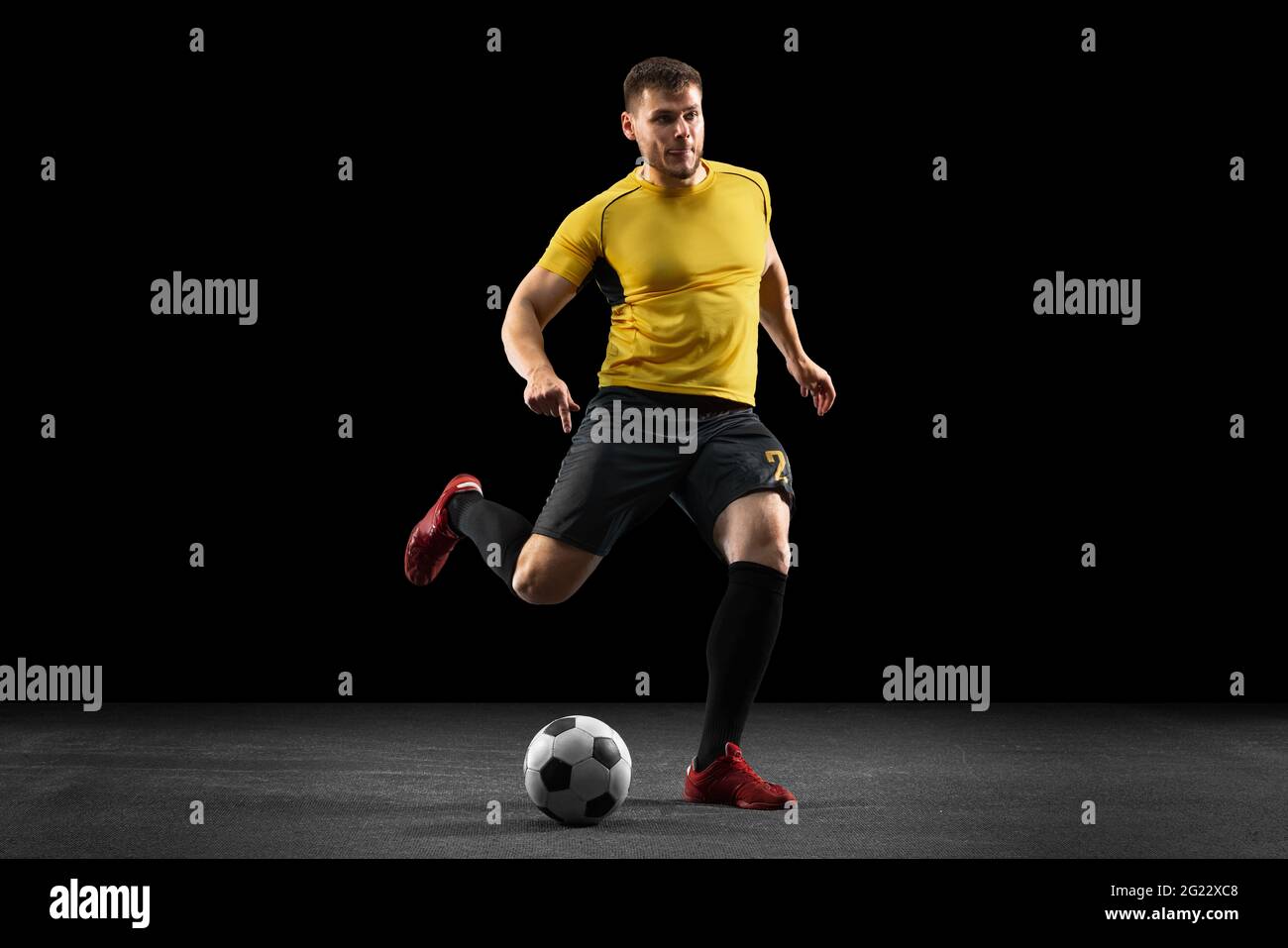 Powerful, flying above the field. Young football, soccer player in ...