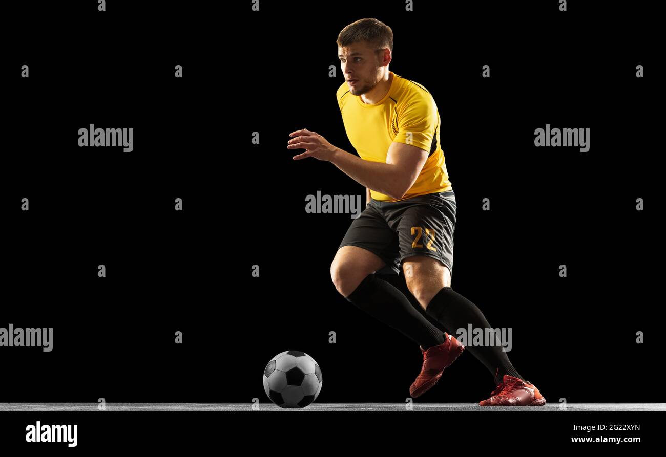 Powerful, flying above the field. Young football, soccer player in ...