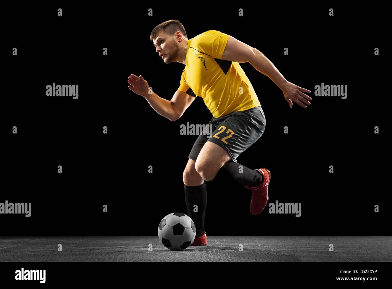 Powerful, flying above the field. Young football, soccer player in ...