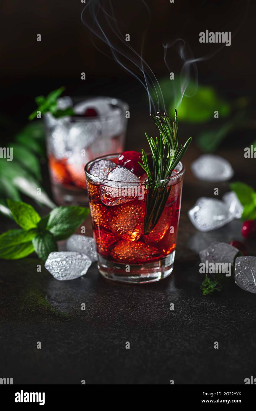 Berry alcoholic cocktail liqueur, vodka, ice and rosemary. Refreshing ...
