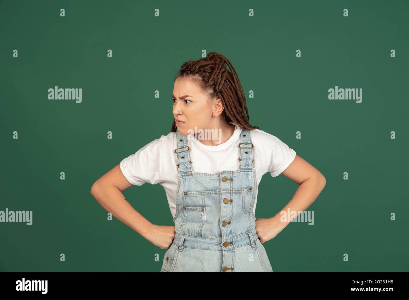 Beautiful female portrait isolated on green studio backgroud. The young ...