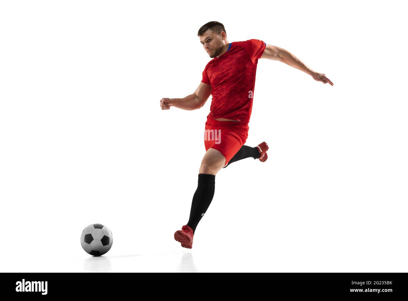 Powerful, flying above the field. Young football, soccer player in ...