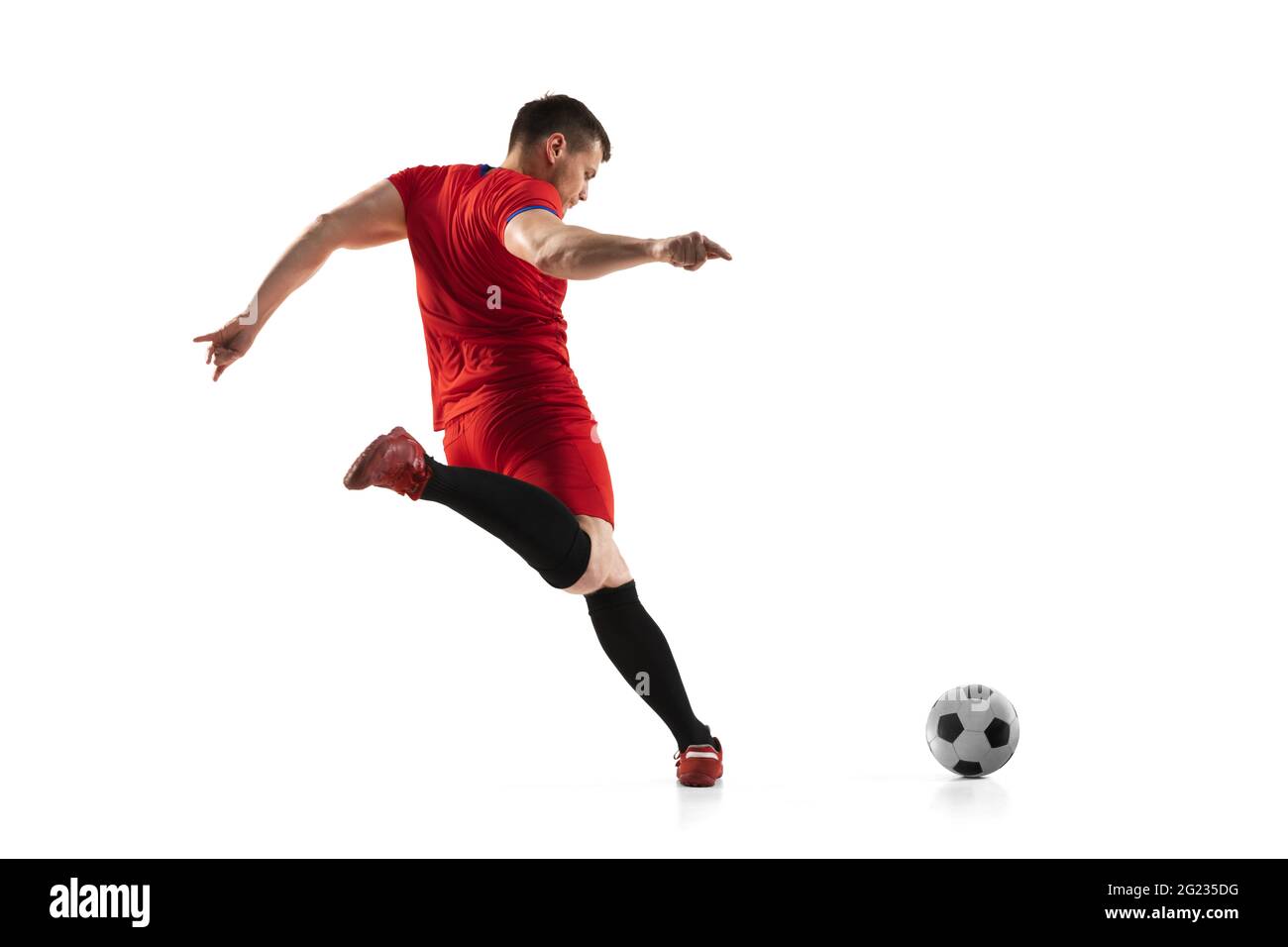 Powerful, flying above the field. Young football, soccer player in ...