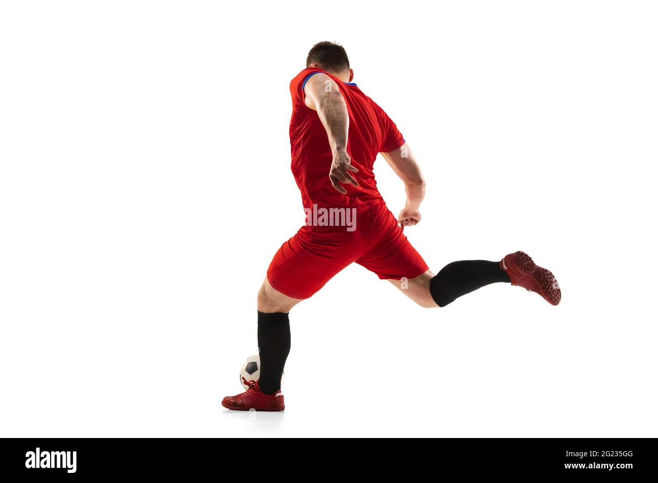Powerful, flying above the field. Young football, soccer player in ...