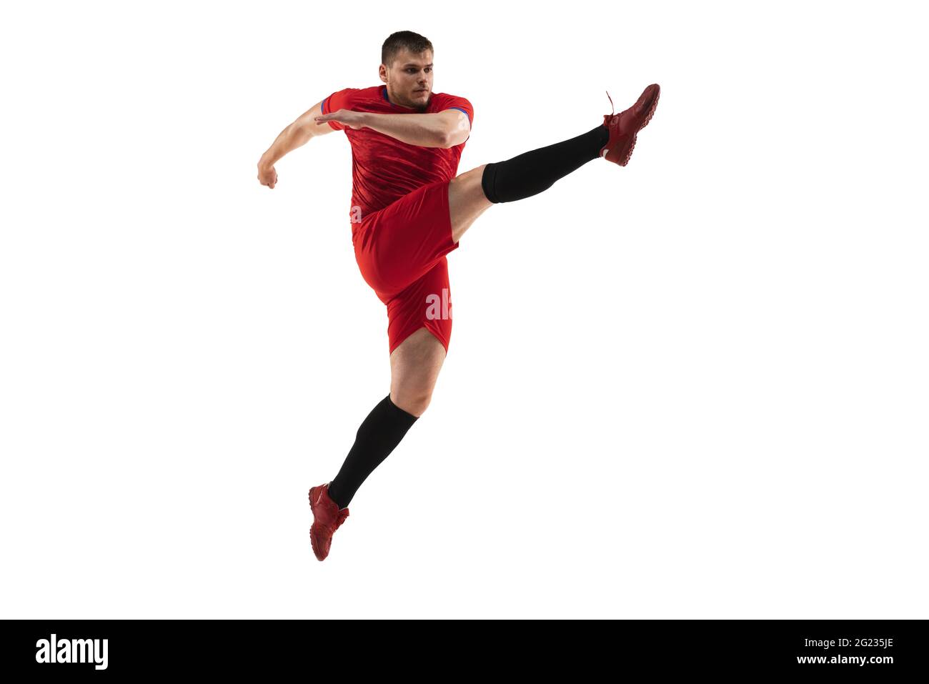 Powerful, flying above the field. Young football, soccer player in ...
