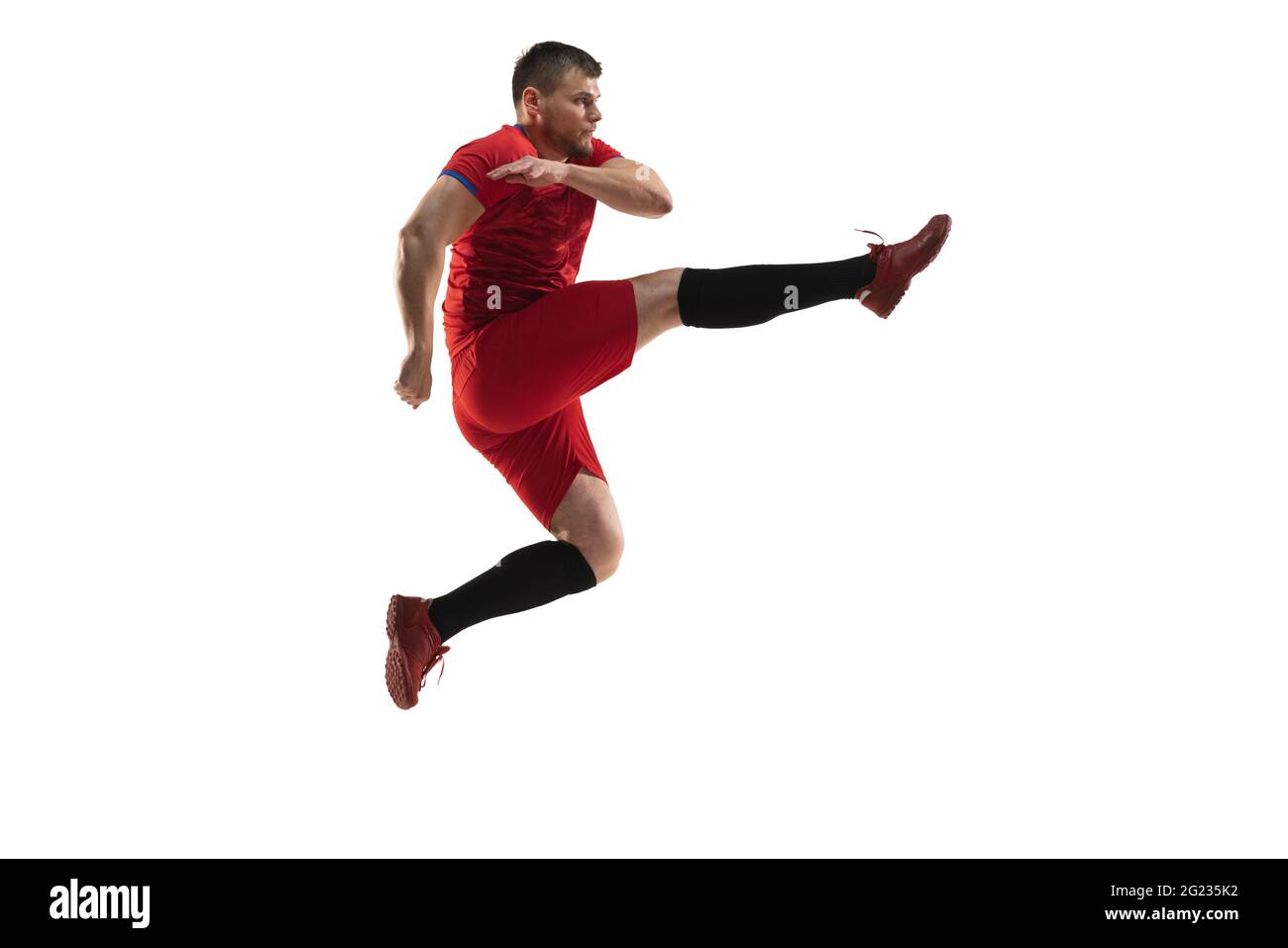 Powerful, flying above the field. Young football, soccer player in ...
