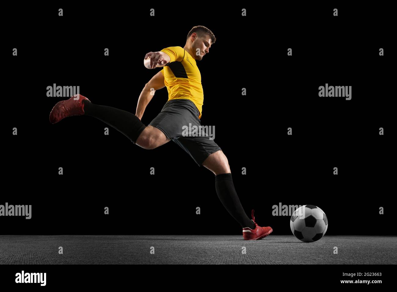 Powerful, flying above the field. Young football, soccer player in ...