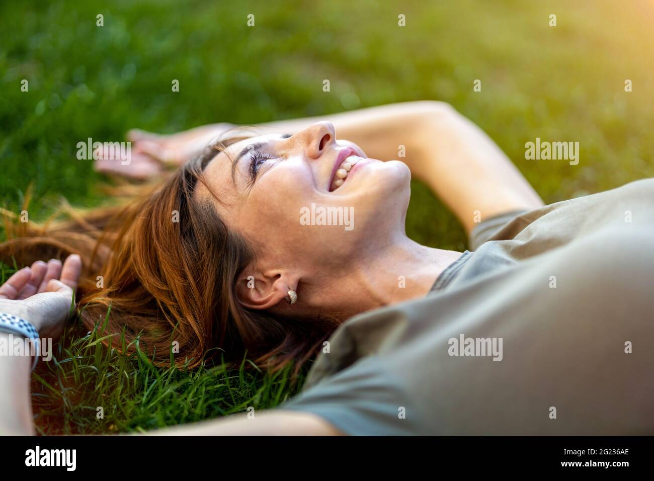 Woman lying in the sun hi-res stock photography and images - Alamy