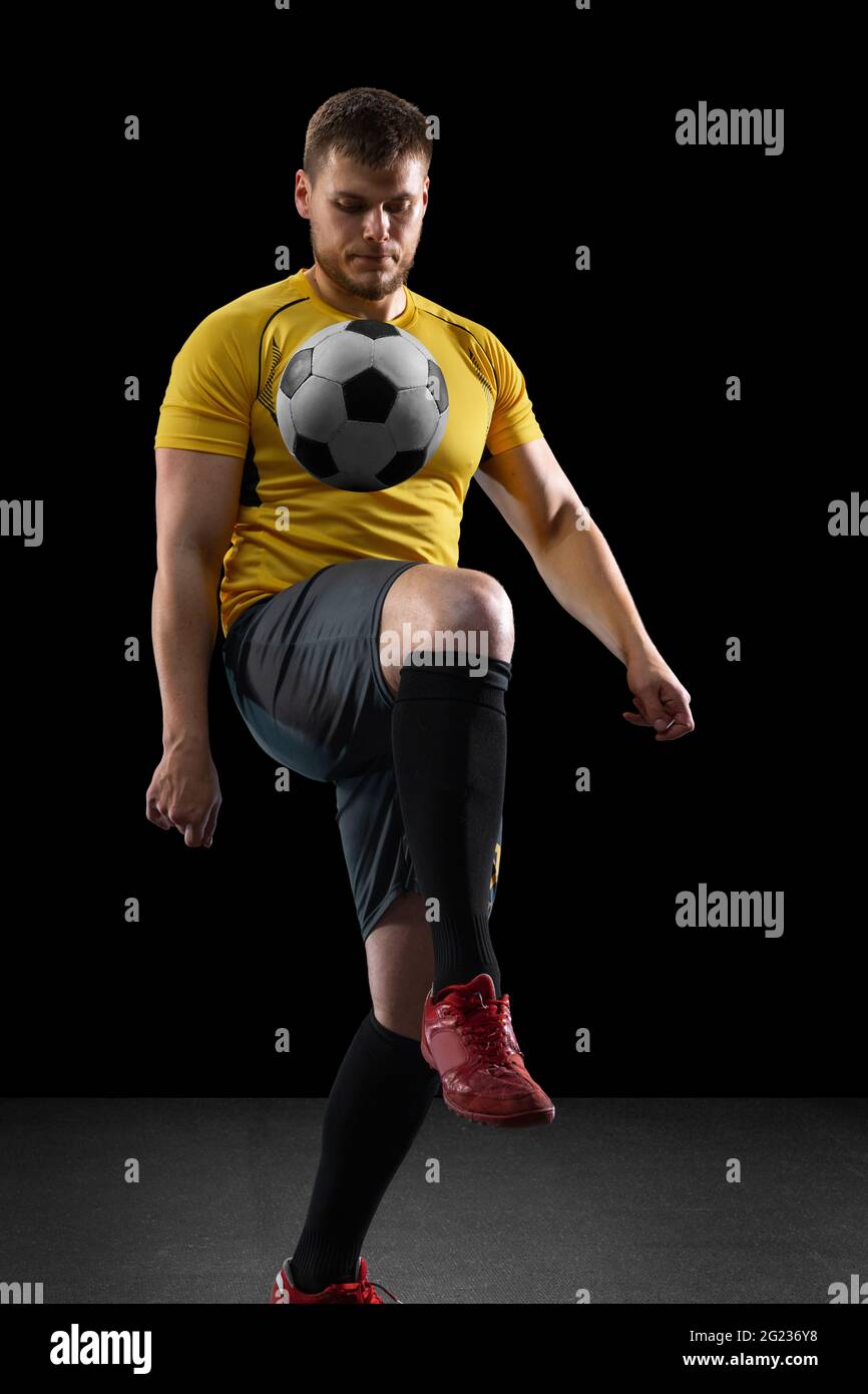 Powerful, flying above the field. Young football, soccer player in ...