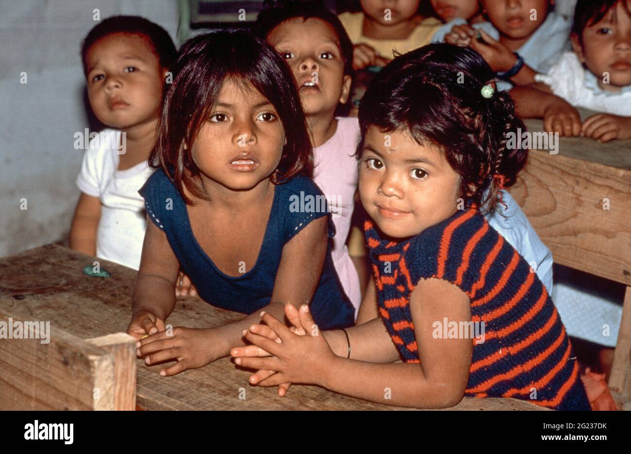 Young children from a childrens home seated at their desks in a ...
