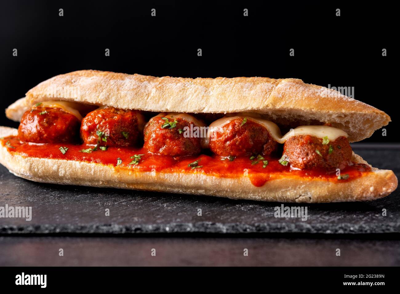 Meatball sub sandwich on black slate background Stock Photo - Alamy