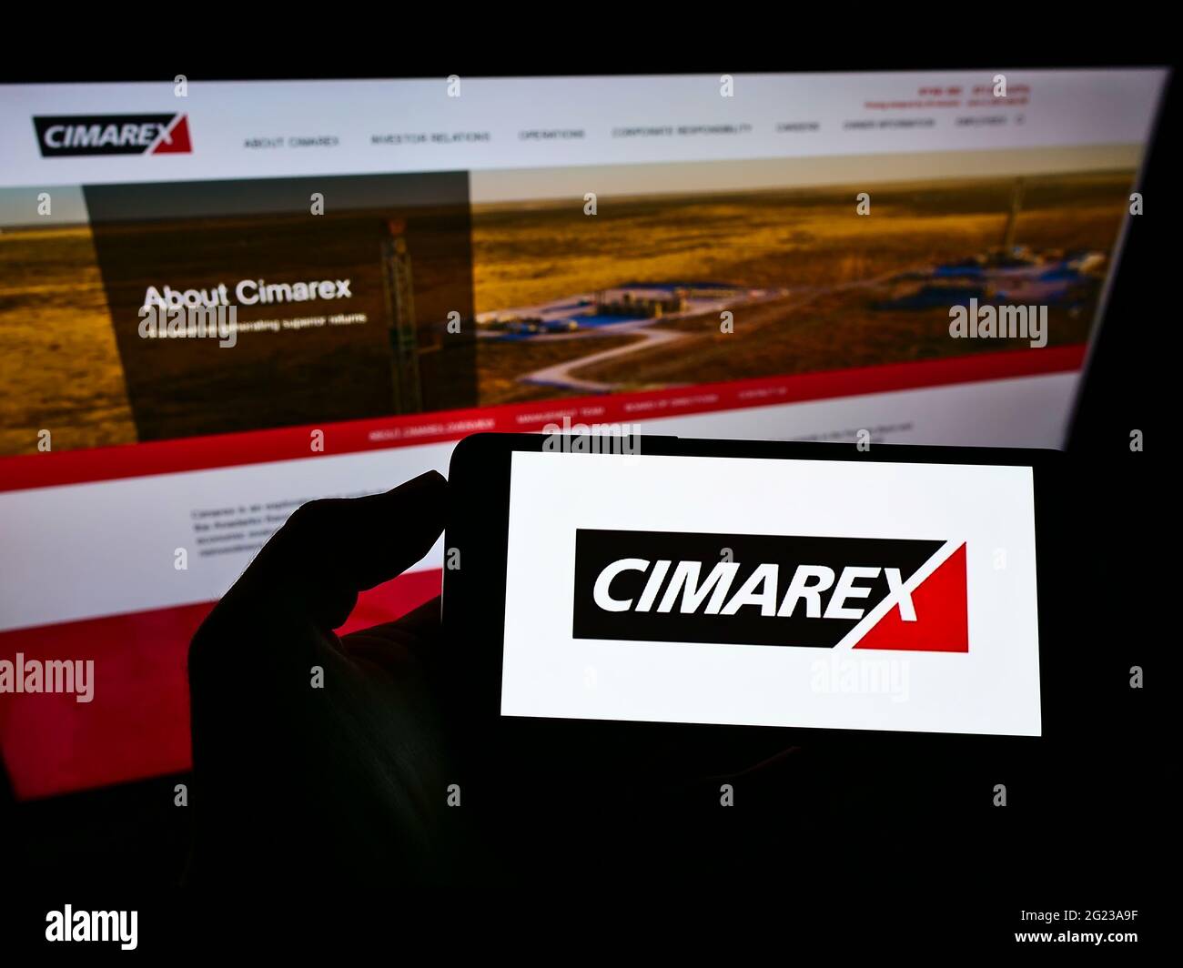Person holding smartphone with logo of US hydrocarbon exploration ...