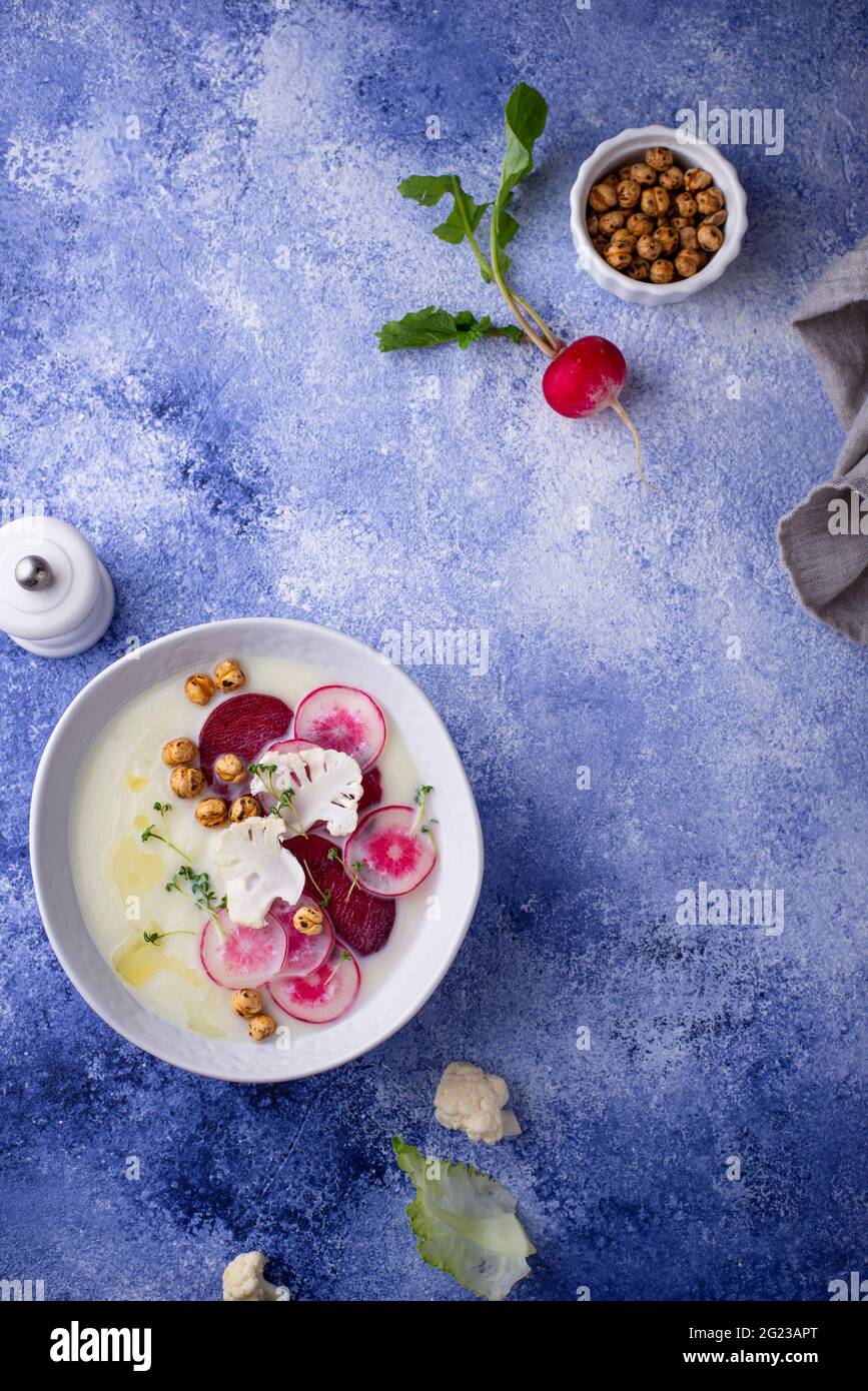 Cauliflower soup puree decorated with radish Stock Photo - Alamy