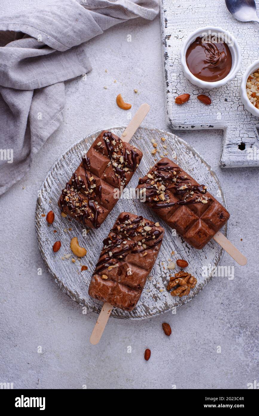 Chocolate ice cream popsicle with nut Stock Photo - Alamy