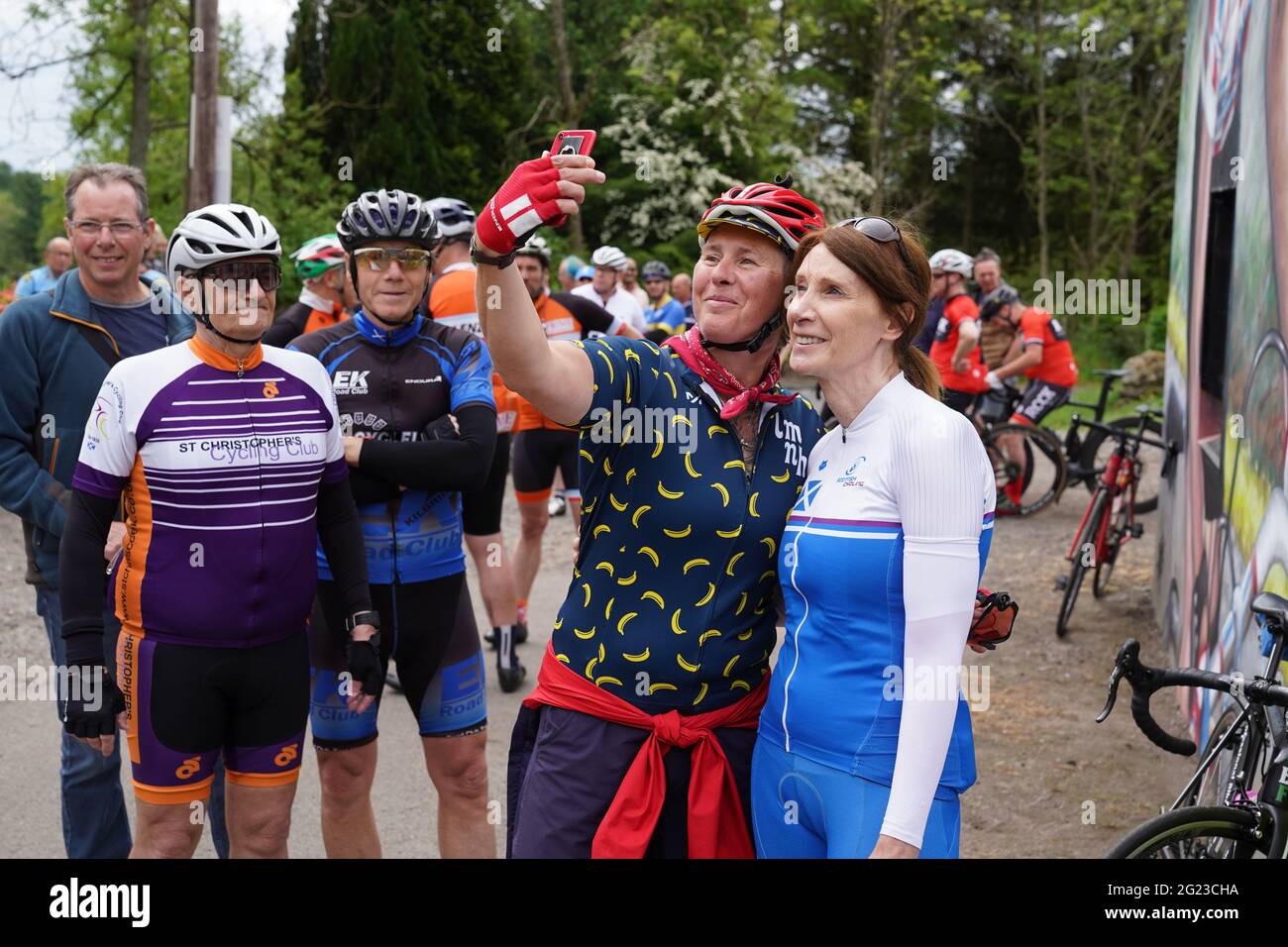 Philippa York, poses for photos with other cyclists, in front of a ...