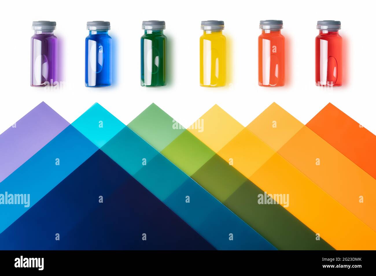 glass vials with rainbow coloured liquid isolated on white background ...