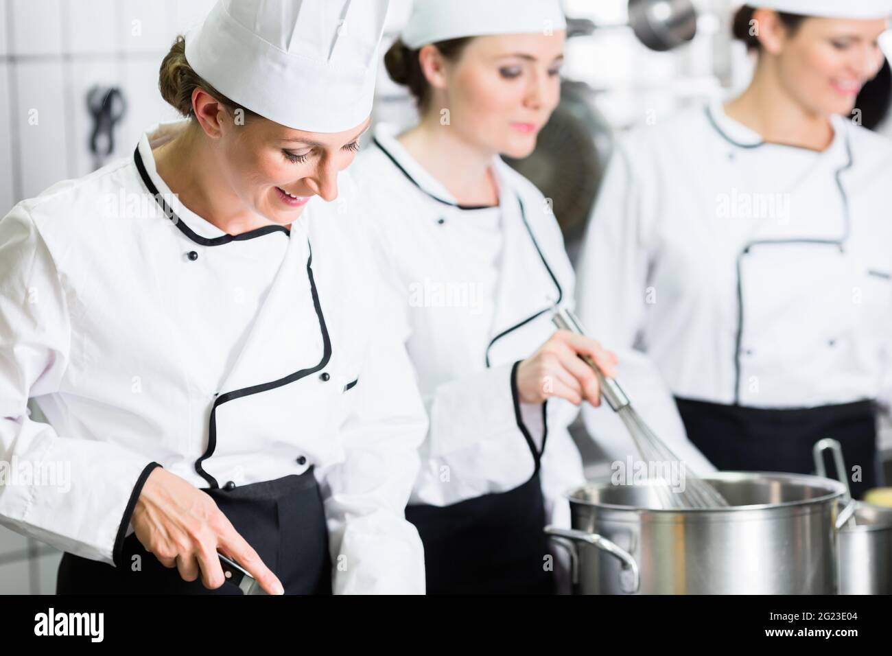 Female chefs at work in industrial kitchen of canteen Stock Photo - Alamy