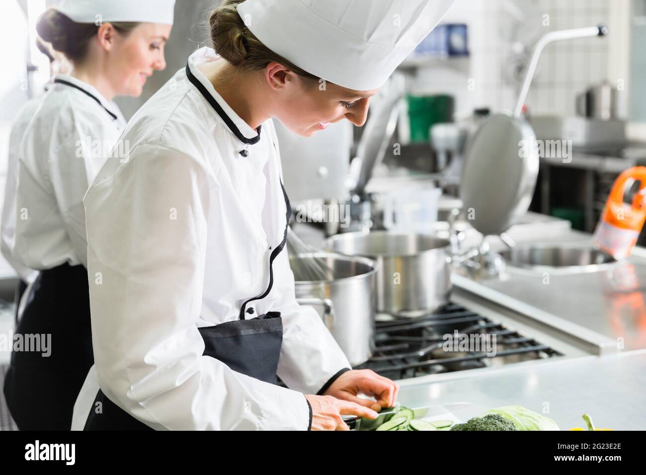 Female chefs at work in industrial kitchen of canteen Stock Photo - Alamy