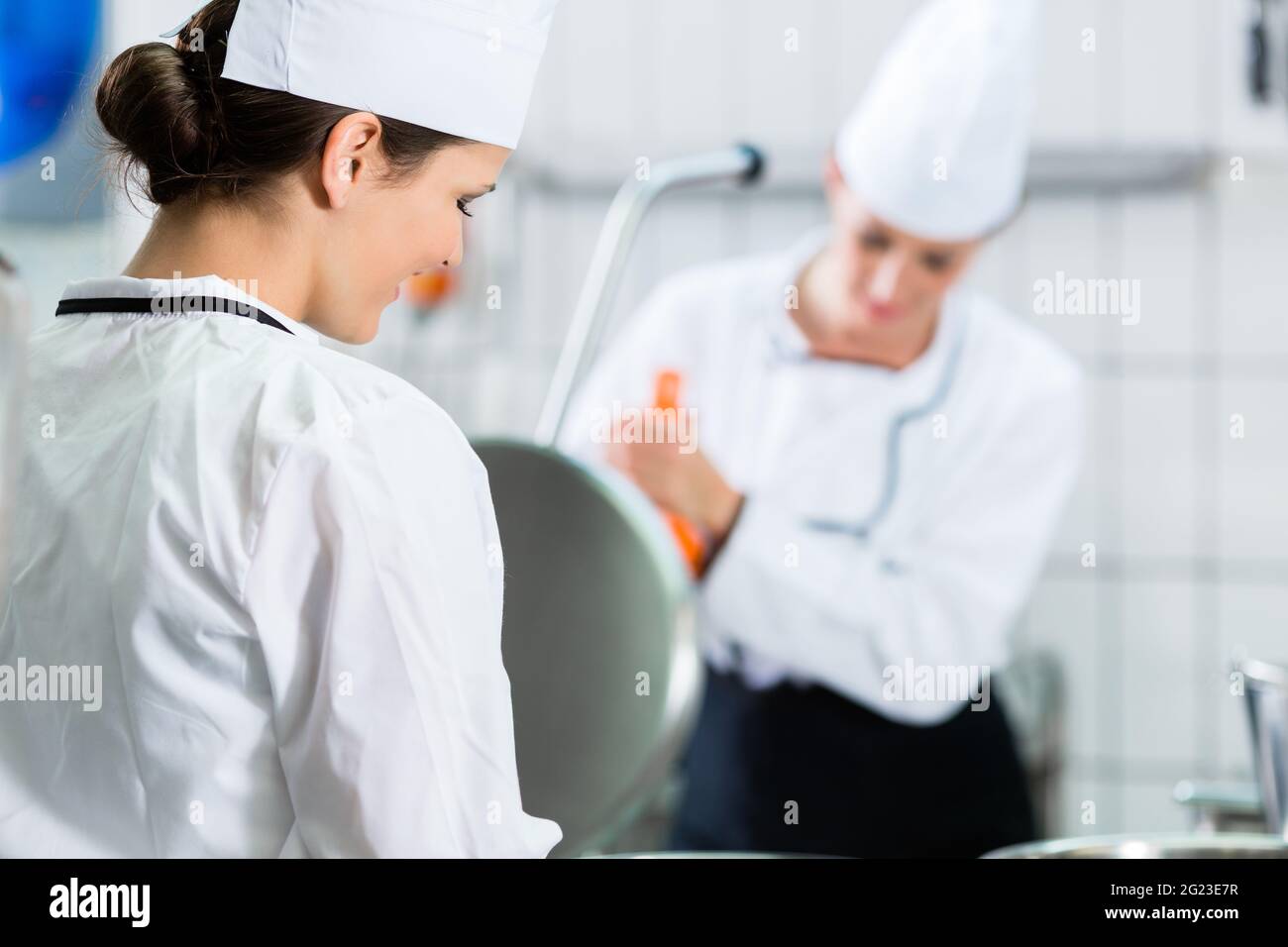 Commercial kitchen with chefs cooking Stock Photo - Alamy