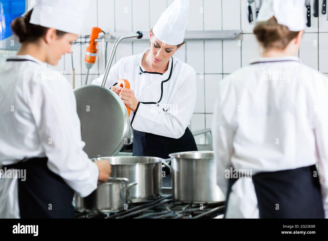 Commercial kitchen with chefs cooking Stock Photo - Alamy