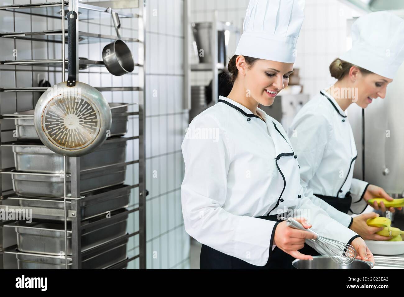 Commercial kitchen with chefs cooking Stock Photo - Alamy