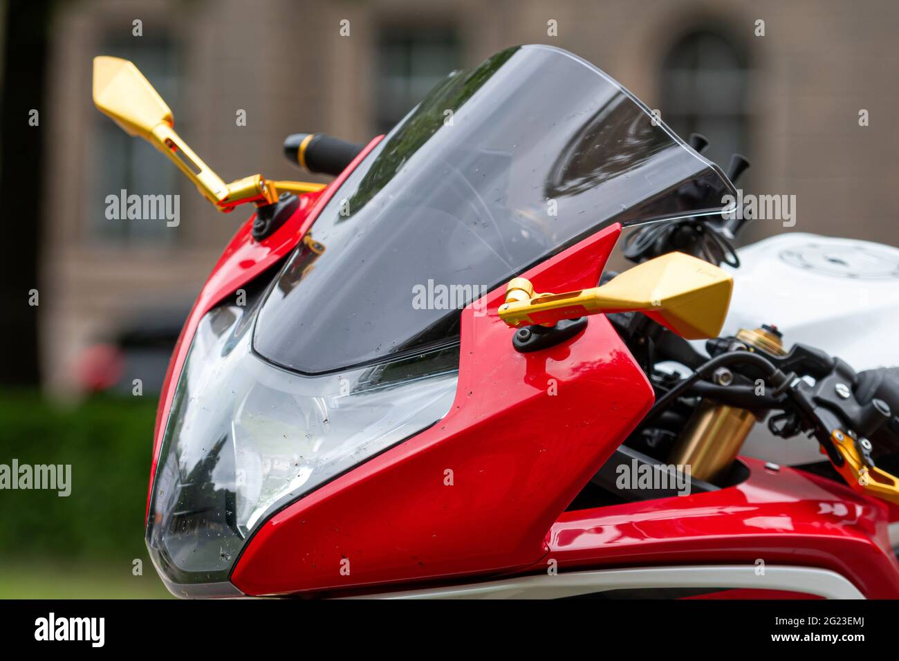 close-up of the headlights of a red sports motorcycle on the street ...