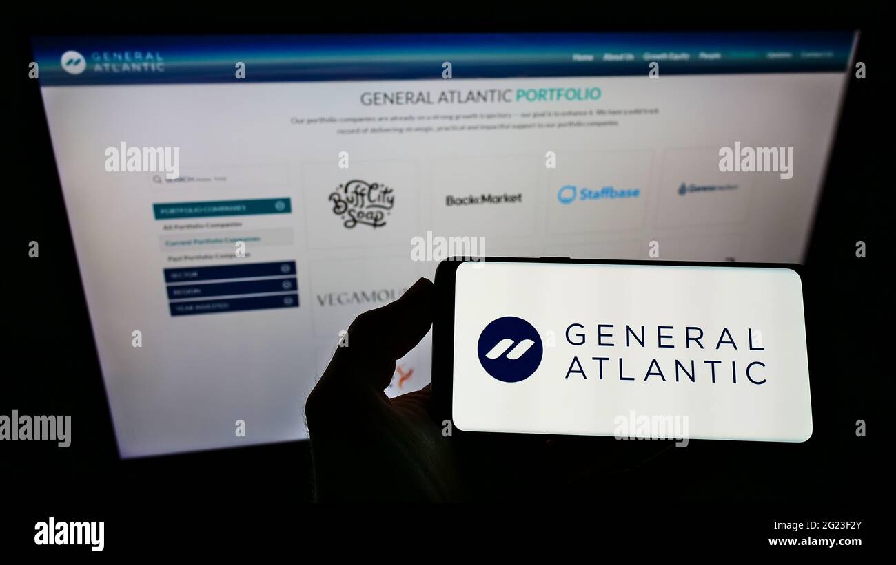 Person holding smartphone with logo of US private equity company ...