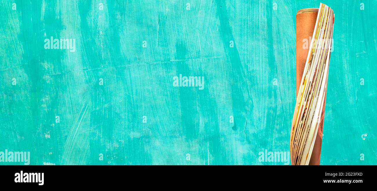 rolled newspaper or magazine on green background, panoramic press,media ...