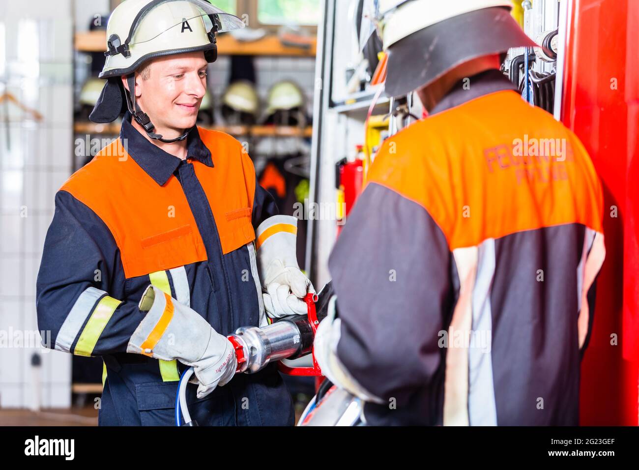 Fire fighter wearing helmet and uniform checking hydraulic cutter at ...